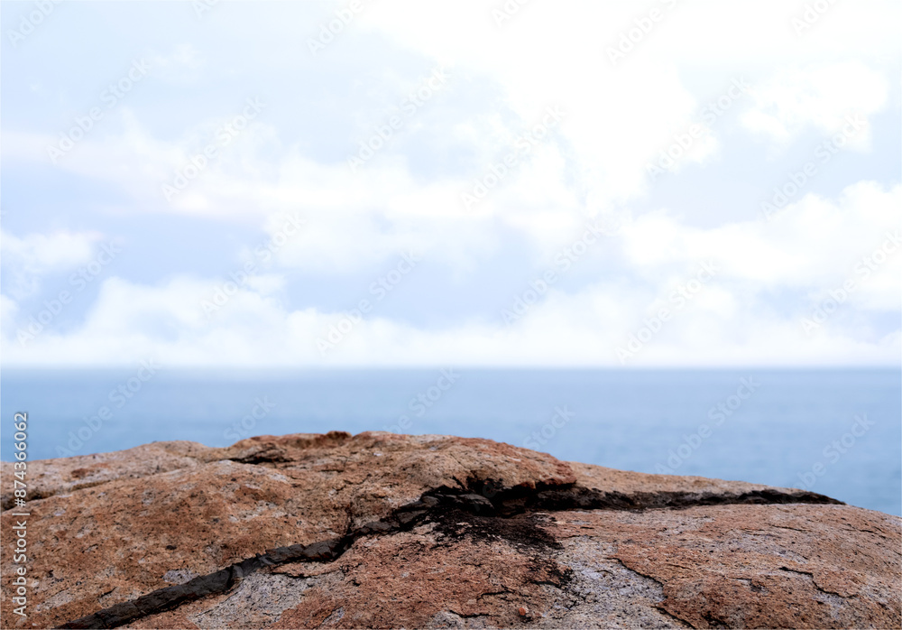 Rock Sea stones with texture surface with blurry blue ocean, cloud sky ...
