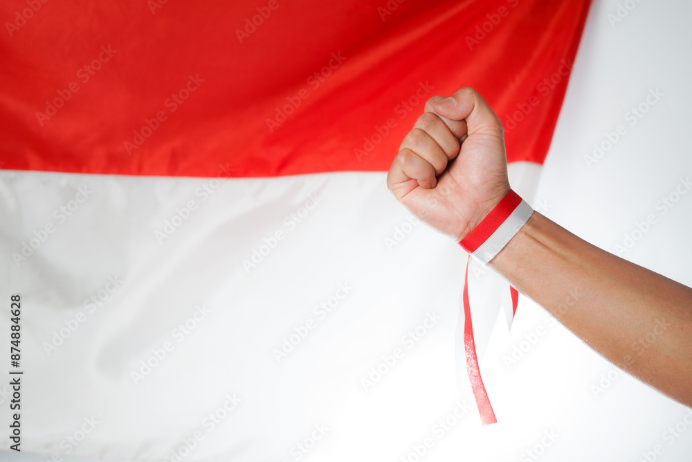Human hand clenched into a fist with red and white ribbon with ...