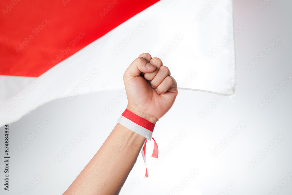 Human hand clenched into a fist with red and white ribbon with ...