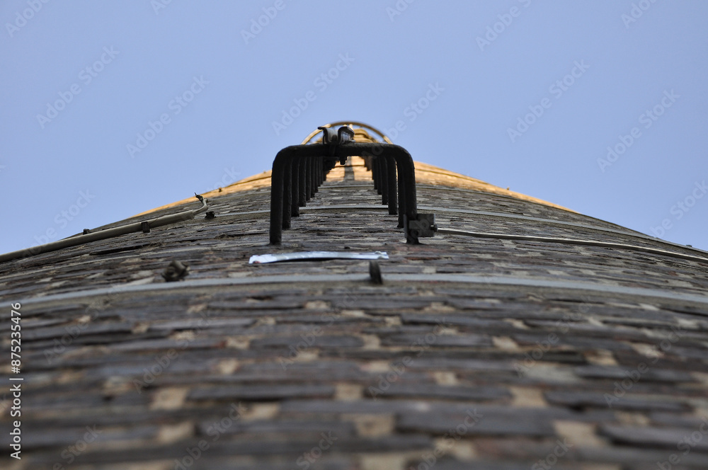 The brick chimney at a metallurgical plant is a massive structure ...