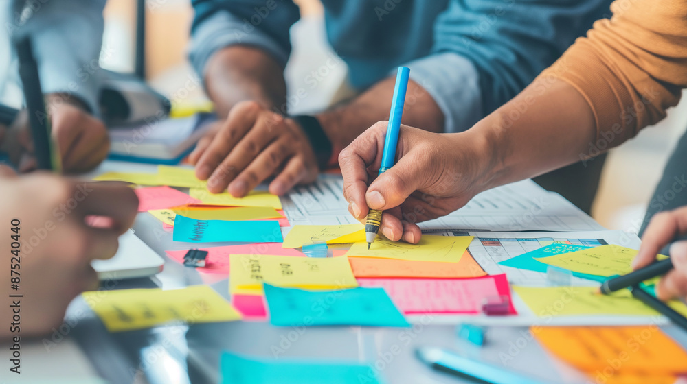 Employees creating a mind map with sticky notes and markers, creative ...