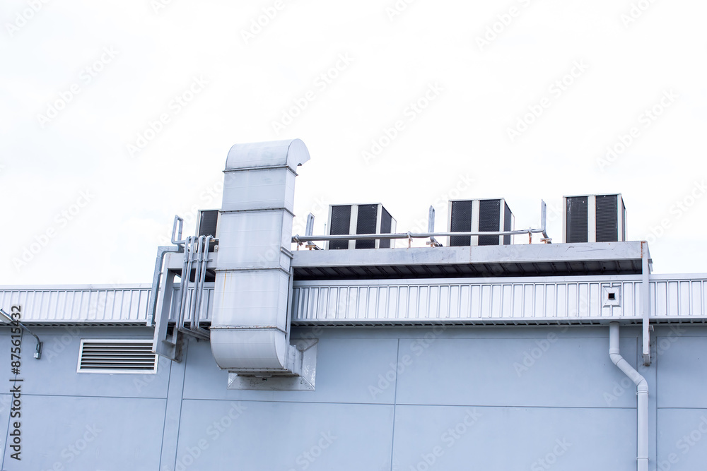 Air conditioner units (HVAC) on a roof of industrial building with ...