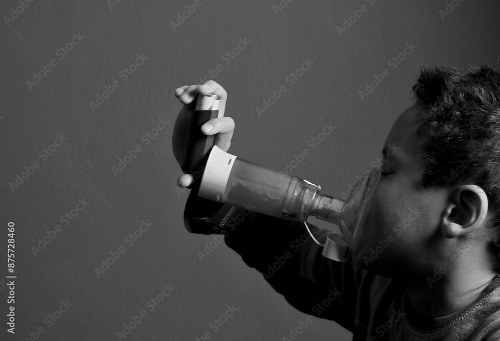 child with flu and inhaler respiratory puff on grey background with ...