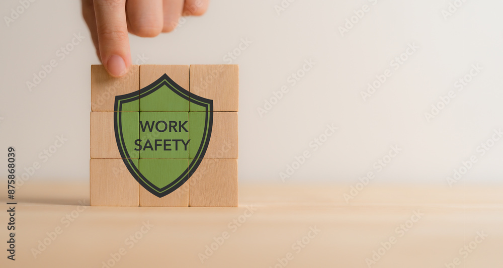 Work safety concept. The wooden cube block with text "WORK SAFETY" on ...