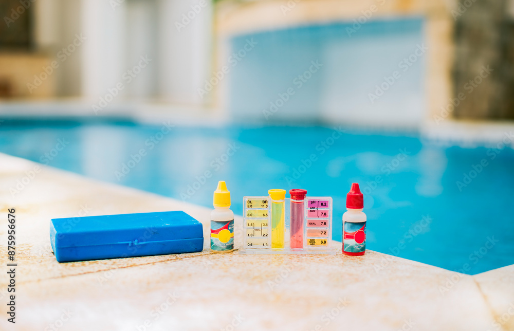Water test kit on the edge of the swimming pool. Chlorine test kit for ...