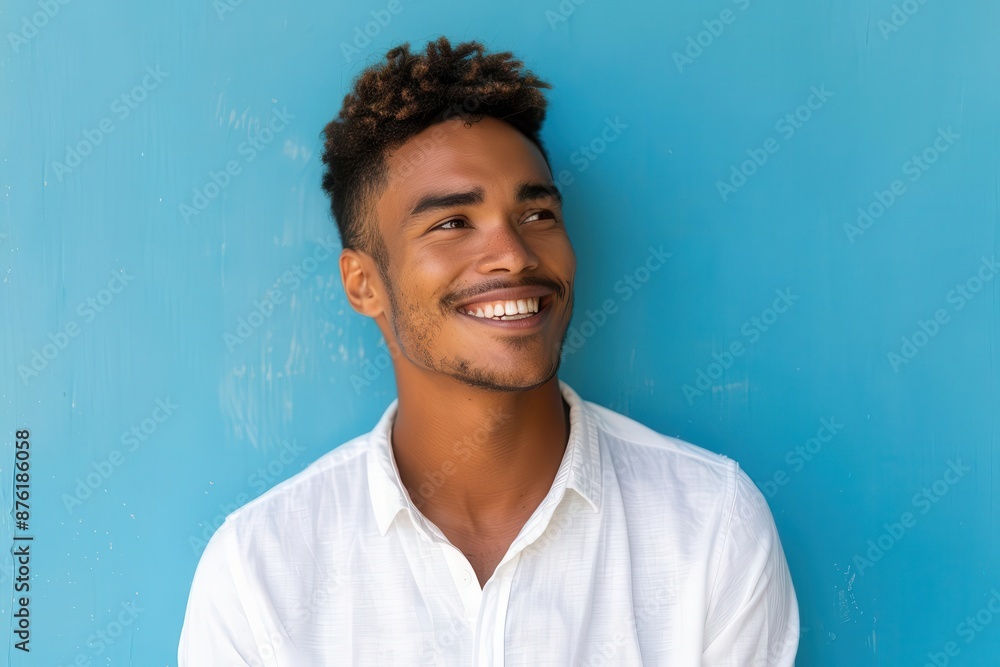 portrait of a charismatic young man with a genuine smile wearing a ...