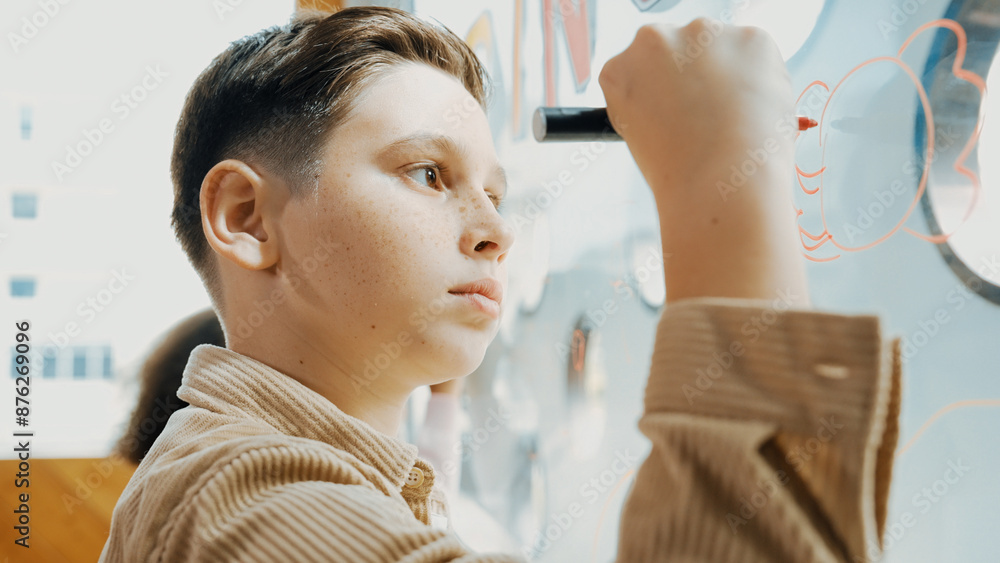 Closeup of caucasian creative student draw beautiful picture at glass ...