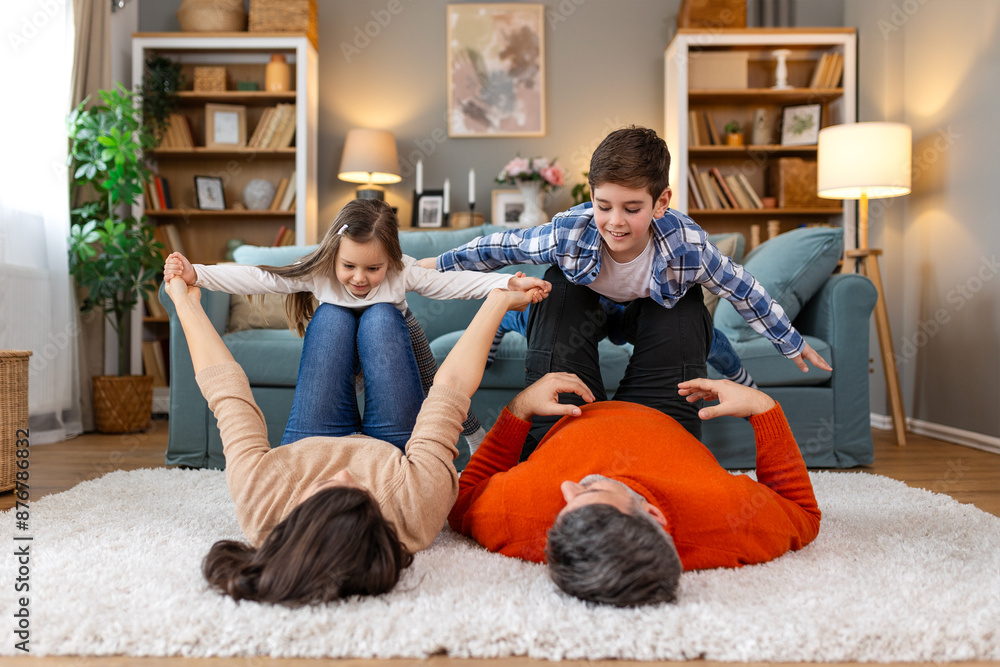 Happy family with two kids playing at home. Family sitting on floor and ...