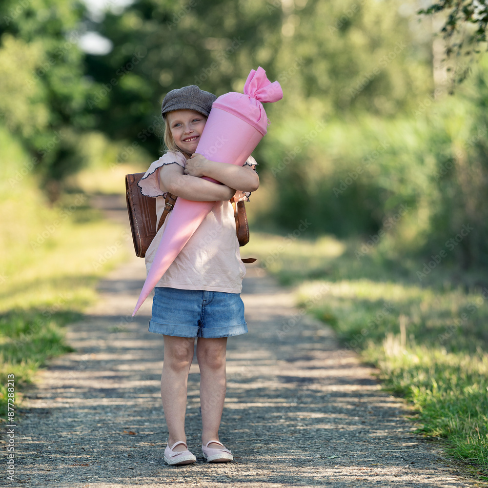 little girl walking in the park with her school cone - first day at ...