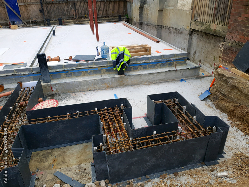 Construction site with workers building a house extension, installing ...