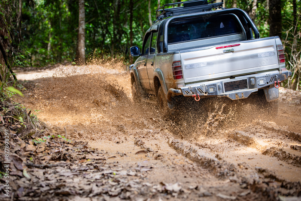 Cars running on off-road roads and splashing mud on natural paths. Off ...
