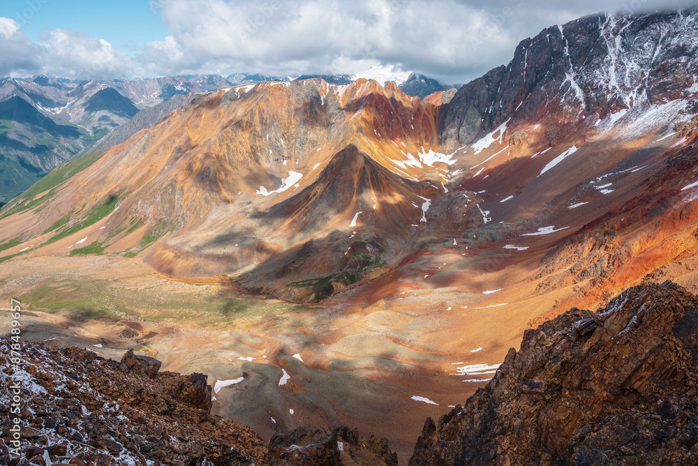 Top view from rock abyss edge to rounded multicolor valley with curved ...