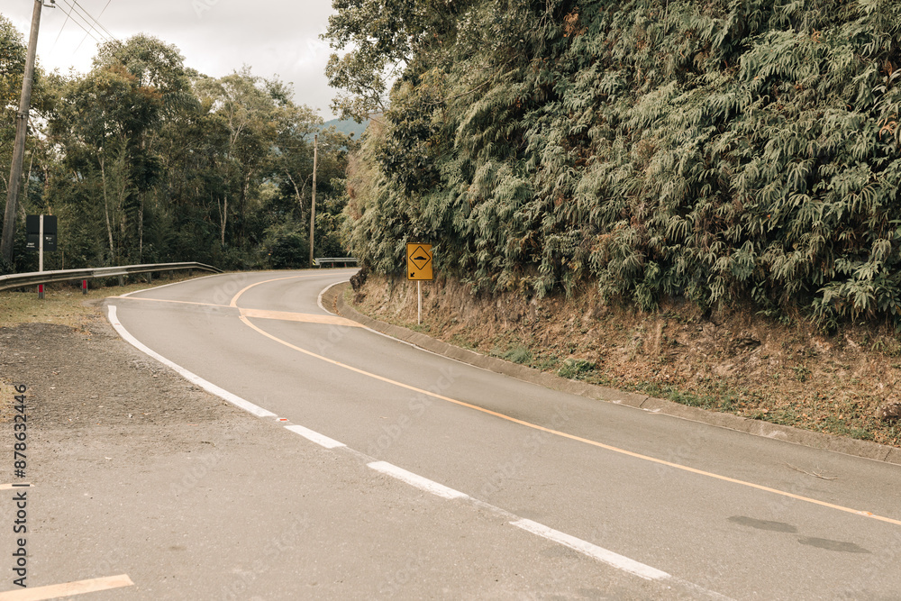 Asphalt street with a speed bump (bump) on the curve that passes ...