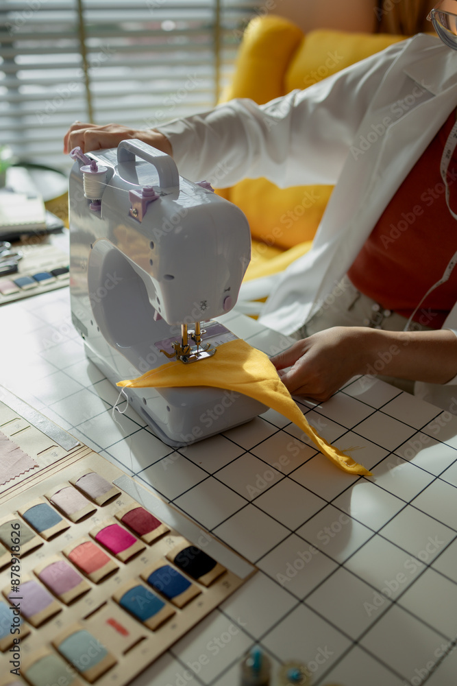 A gorgeous new face designer is using her little sewing machine to sew ...