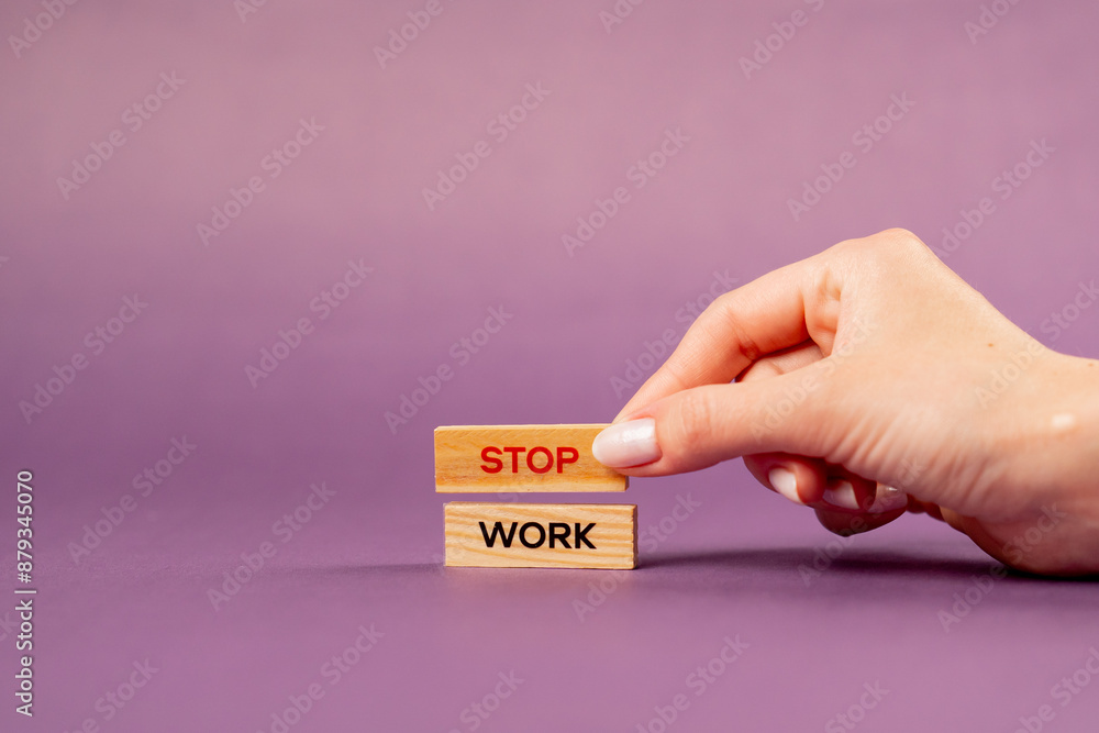 violet warm background with shadows woman hand put wooden cubes with ...