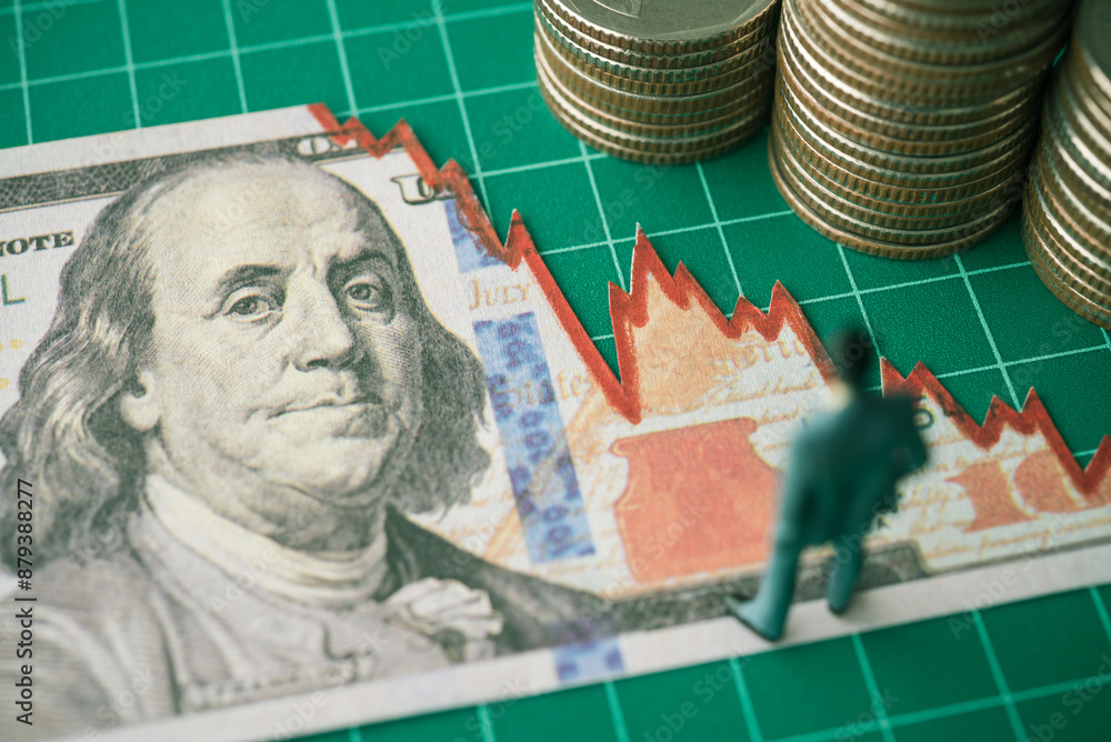 Businessman looking at US dollar banknote tear off as falling down ...