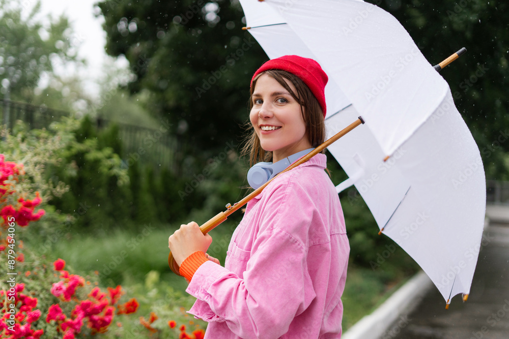 Smiling happy woman and rain feeling water in the city with umbrella ...