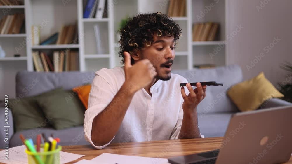 Angry young indian man yelling at mobile phone recording voice ...