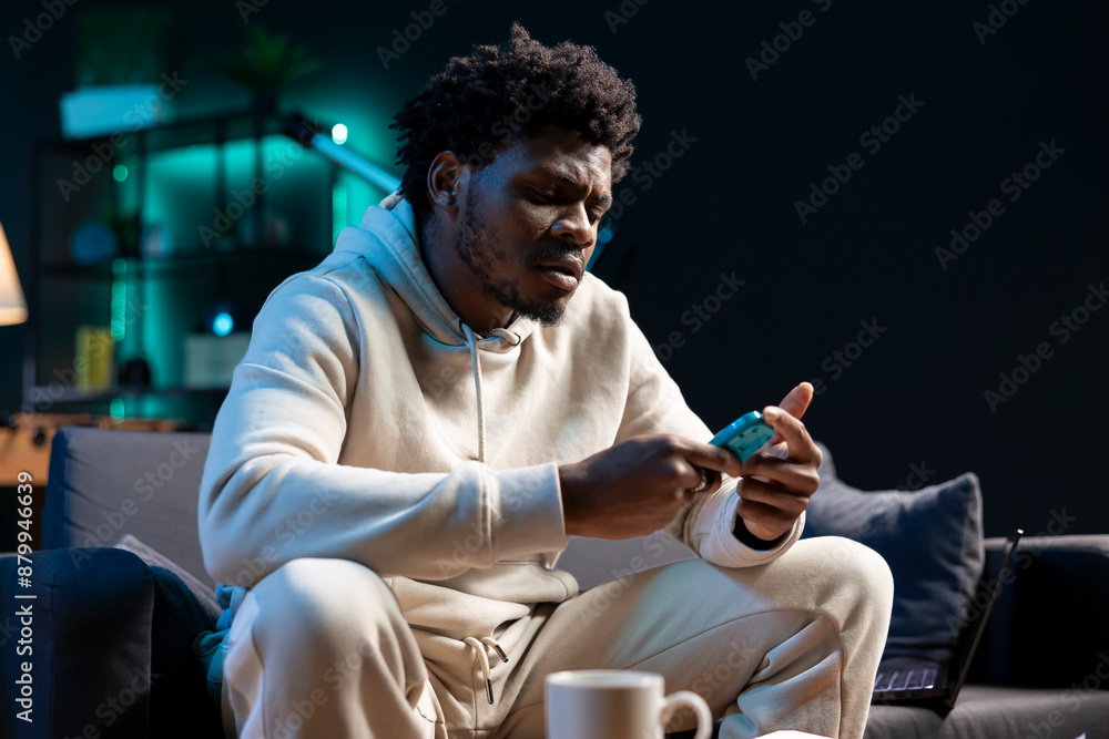 BIPOC man using pulse oximeter to monitor level of blood oxygen ...