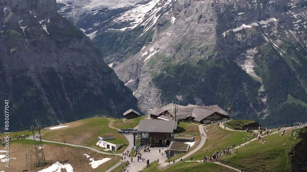 Drone descends tilting up as cable cars arrive at the overlook for ...
