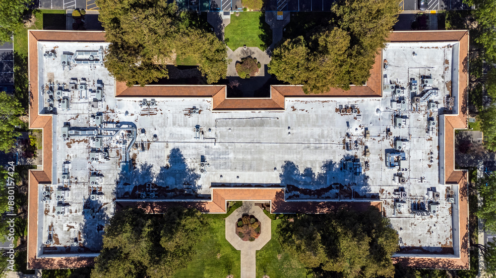 Aerial top down drone view of a large symmetrical office building with ...