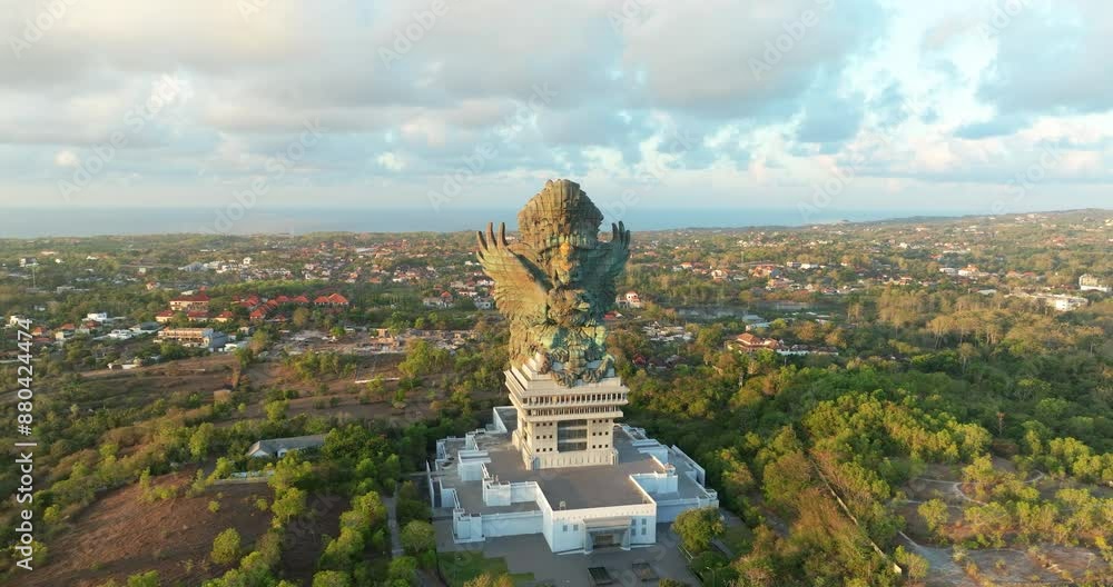 Drone Aerial view 4k Statue of Vishnu in Garuda Wisnu Kencana Cultural Park at sunrise. Bali's ...