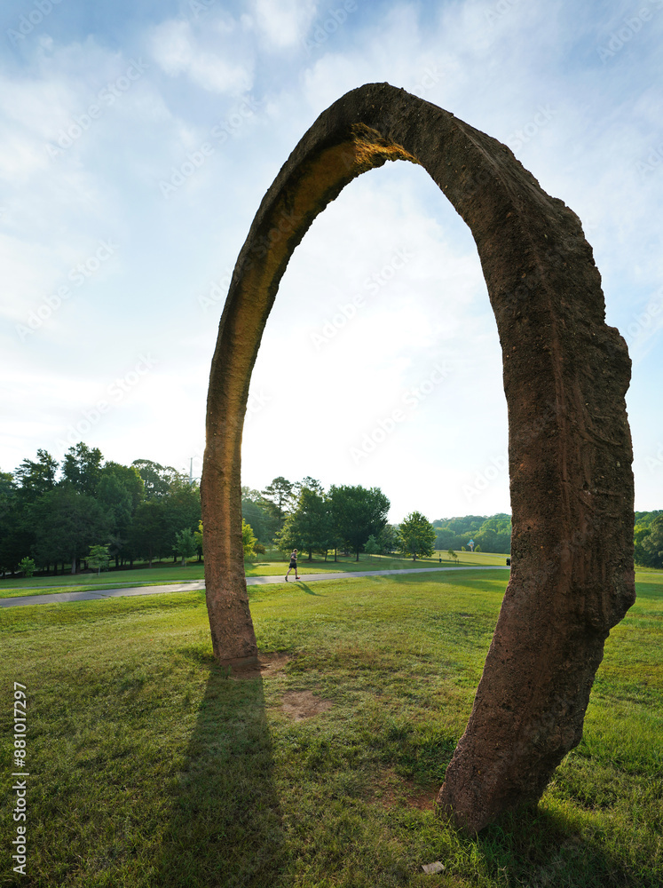Raleigh, NC - USA - 7-9-2024: A man runs past the Gyre sculpture by ...