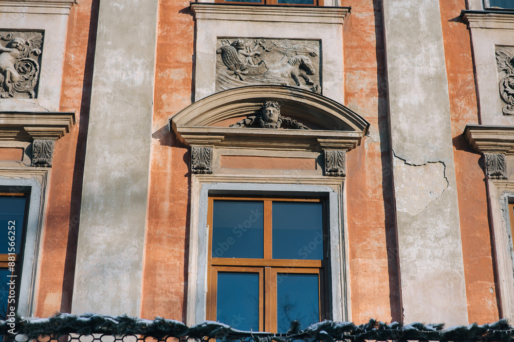 Old decorative architecture of Lviv, Ukraine.Windows on the red facade ...