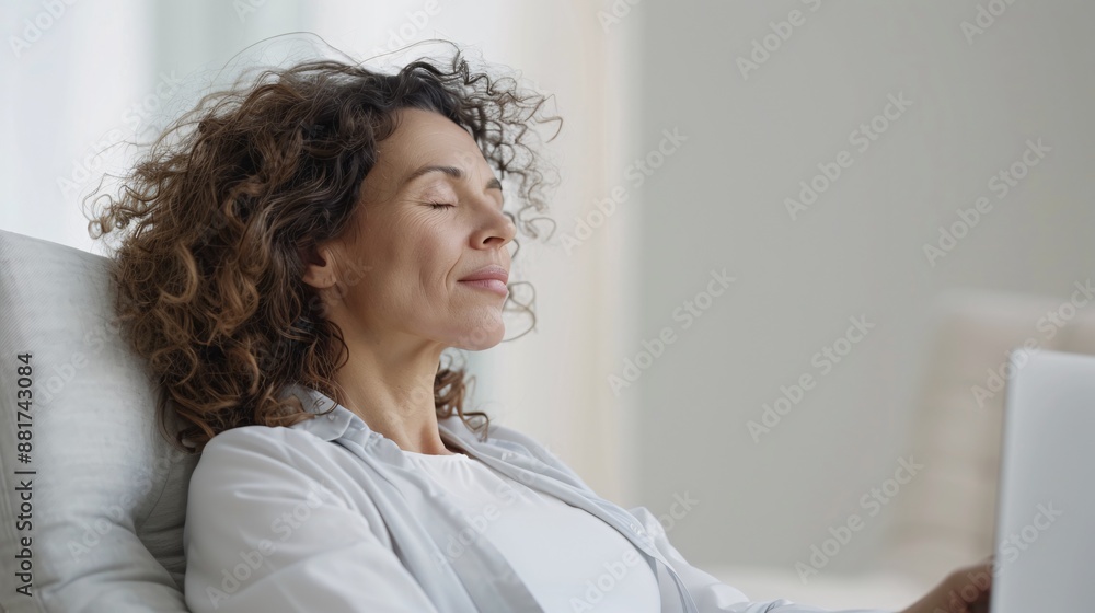 Side profile of a mid-aged woman practicing progressive muscle ...