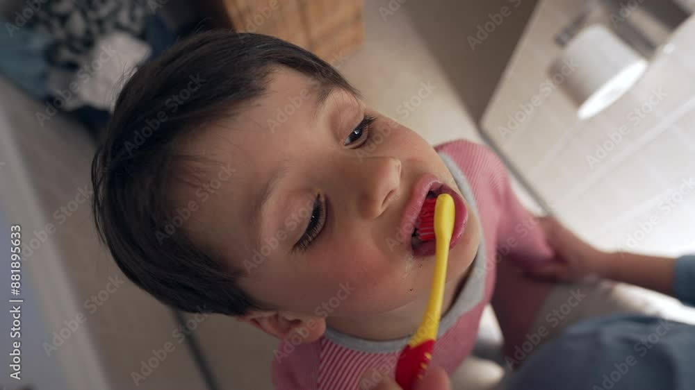 Child brushing teeth with help from a parent, highlighting the ...