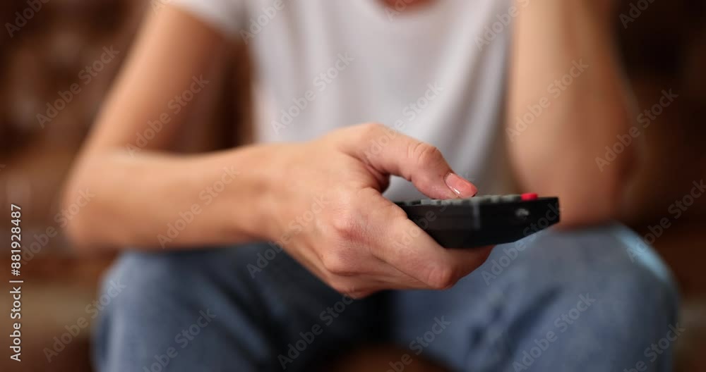 Woman with remote control watching TV at home. Passive viewing of TV ...