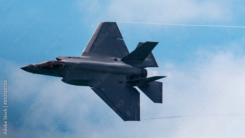 F-35 Lightning II Fighter Jet Flying Against a Blue Sky With Clouds ...