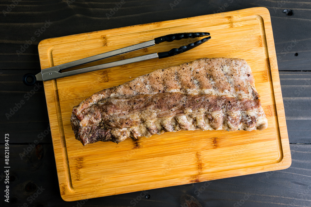 Roasted Slab of Baby Back Ribs on a Cutting Board: Whole slab of pork ...
