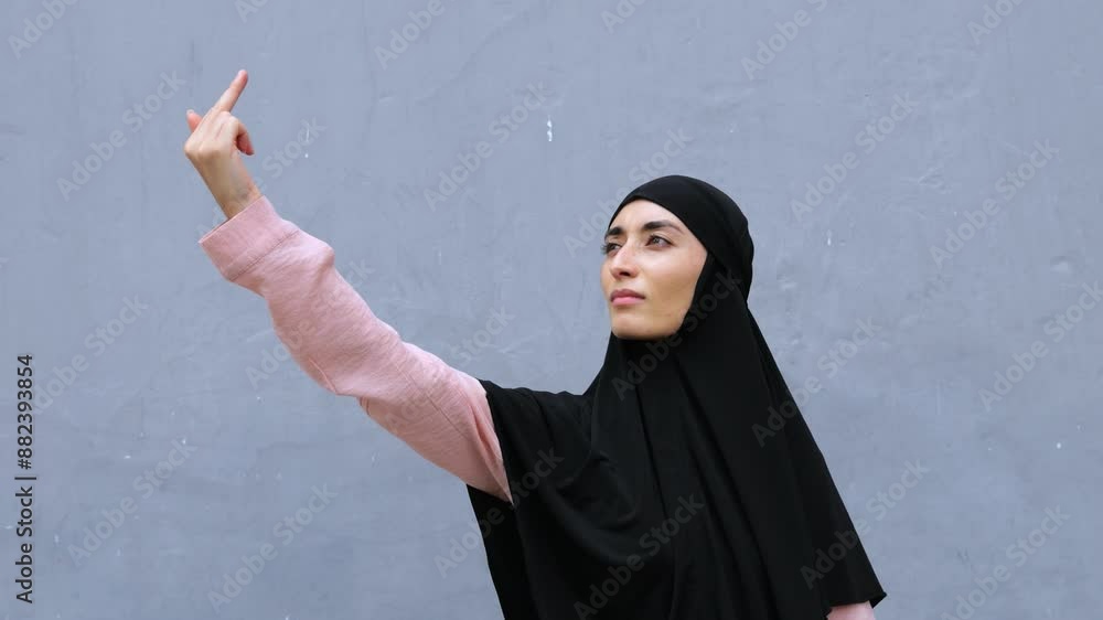 Muslim woman in hijab shows protest gesture middle finger. Gesture ...