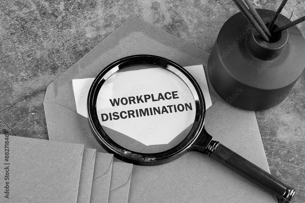 A concept image with letters WORKPLACE DISCRIMINATION appeared through ...