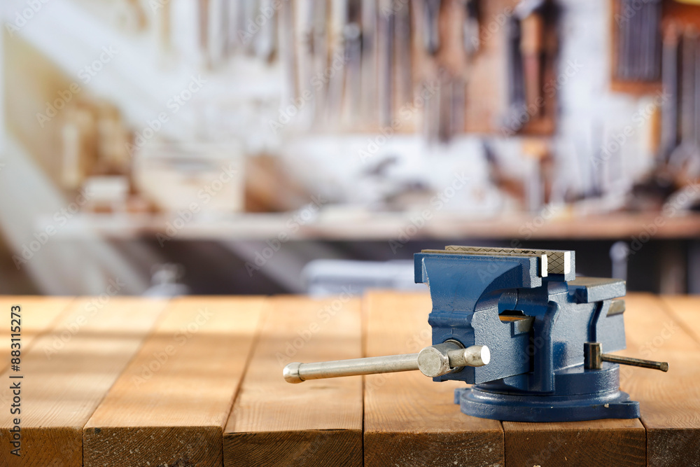 Mechanic bench vice on a wooden workbench in a craftsman's workshop. A ...