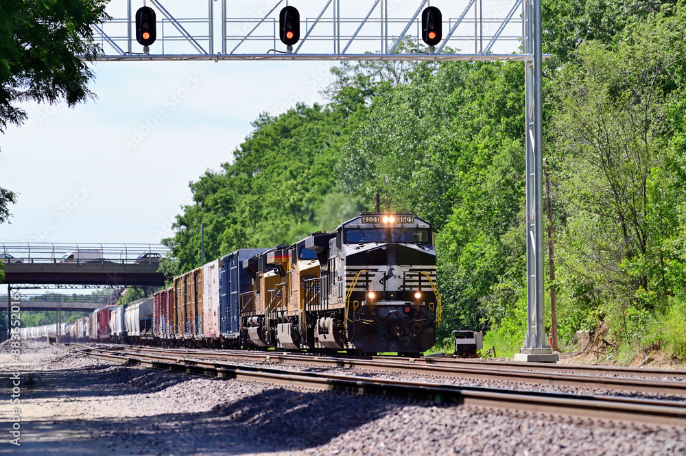 Three locomotives, led by an off-road Norfolk Southern Railway unit ...