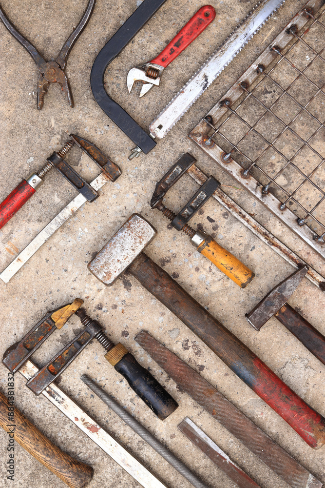 Old construction tools laid out on a concrete background, top view ...