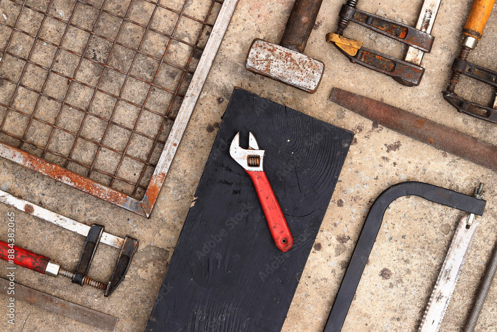 Old construction tools laid out on a concrete background, top view ...