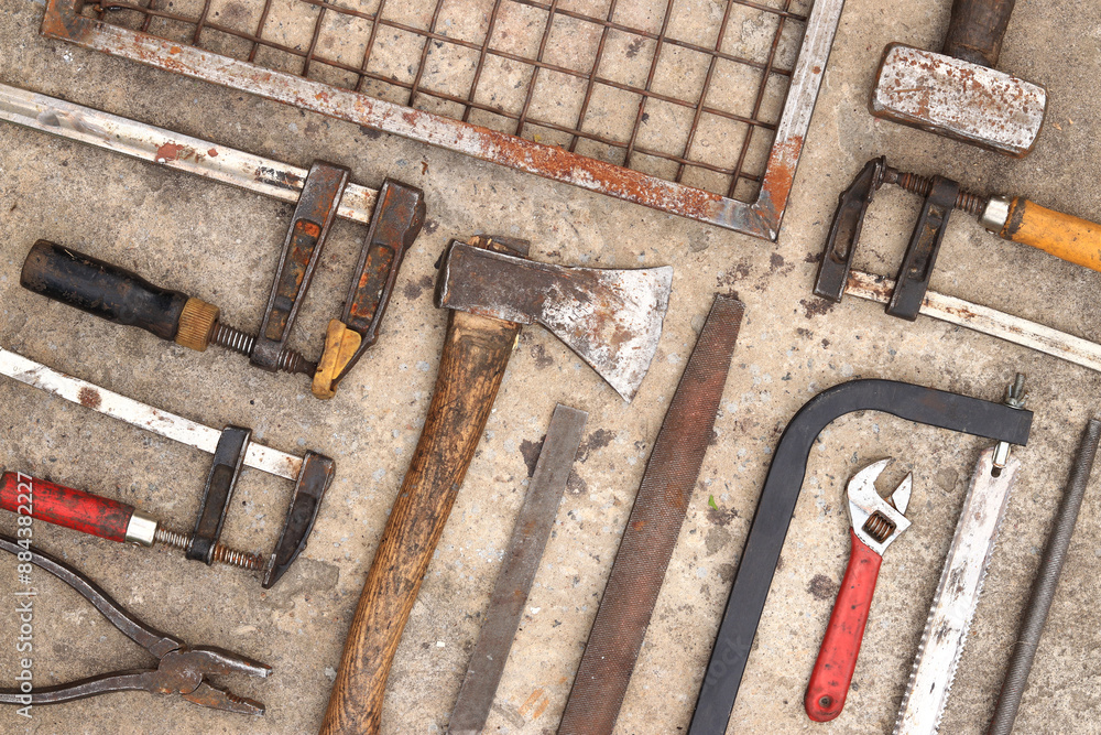 Old construction tools laid out on a concrete background, top view ...