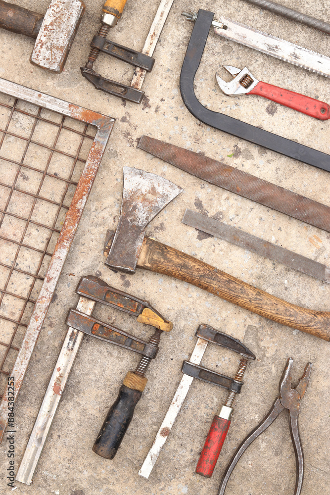 Old construction tools laid out on a concrete background, top view ...