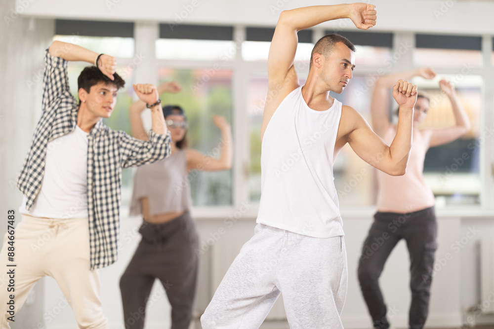 During hip hop dance lesson, guy leads, conducts classes, teaches ...