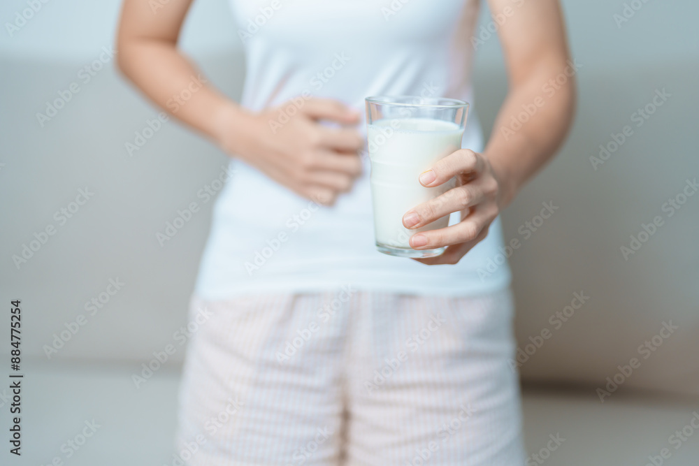Lactose intolerance and Milk allergy concept. woman hold Milk glass and having abdominal cramps ...