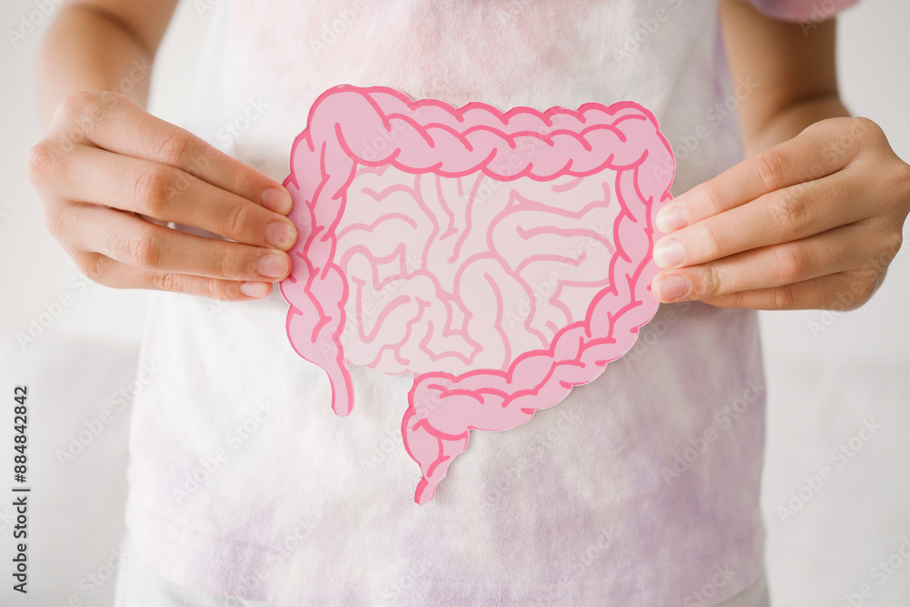 Preteen girl hands holding intestine shape, healthy bowel digestion ...