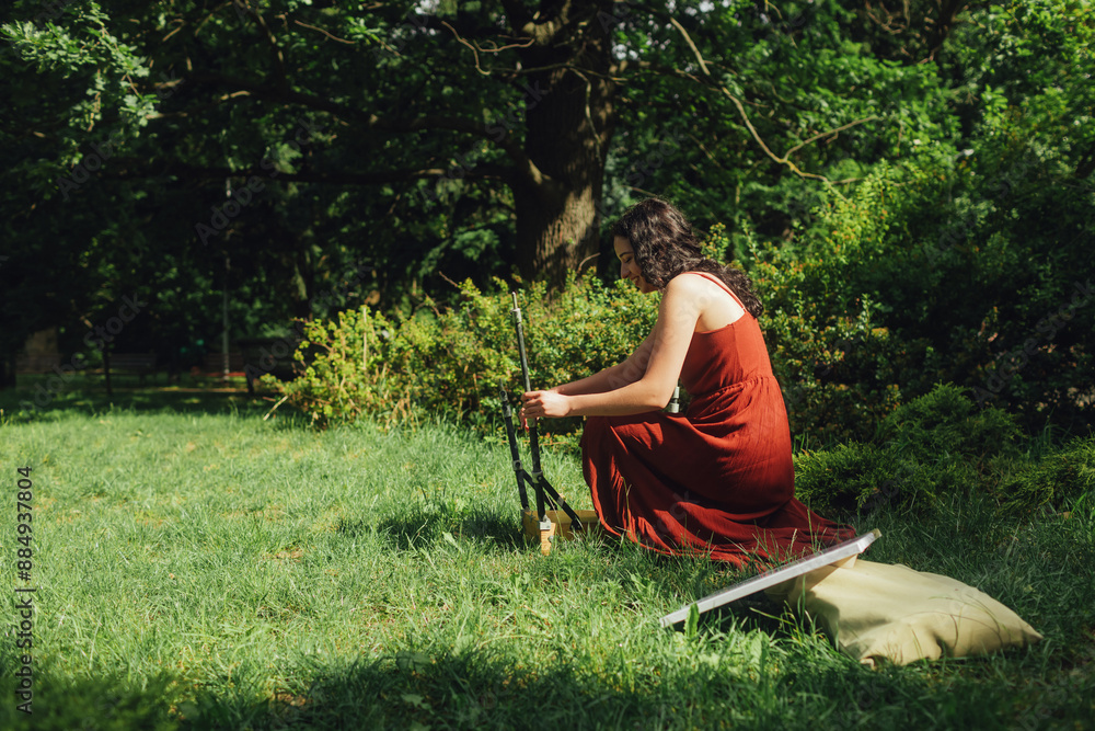 Female artis paints a picture in the park. Mindfulness, art therapy ...
