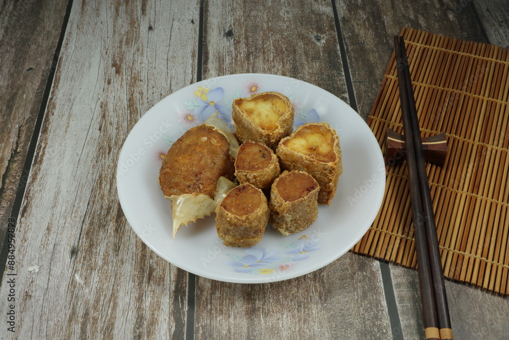 Pile of deep fried crab meat wrapped with tofu sheet. Famous and ...
