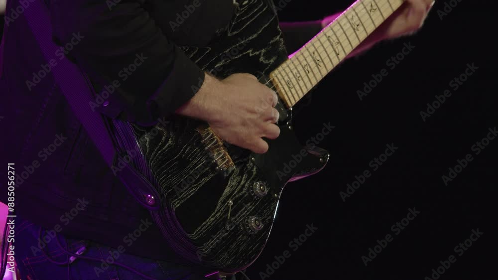 Musician plays beautiful electric guitar on stage during performance ...