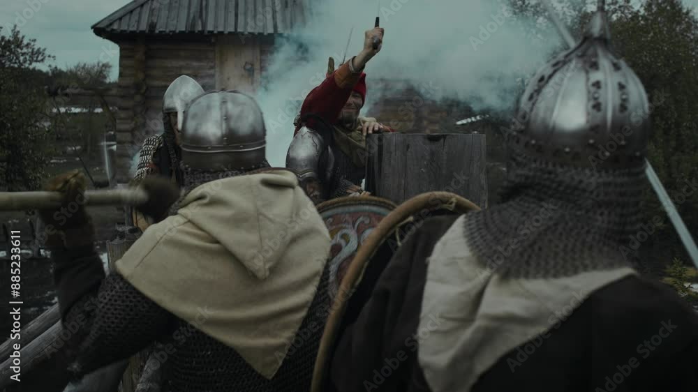 Medium full rear shot of two medieval soldiers clad in chainmail armour ...