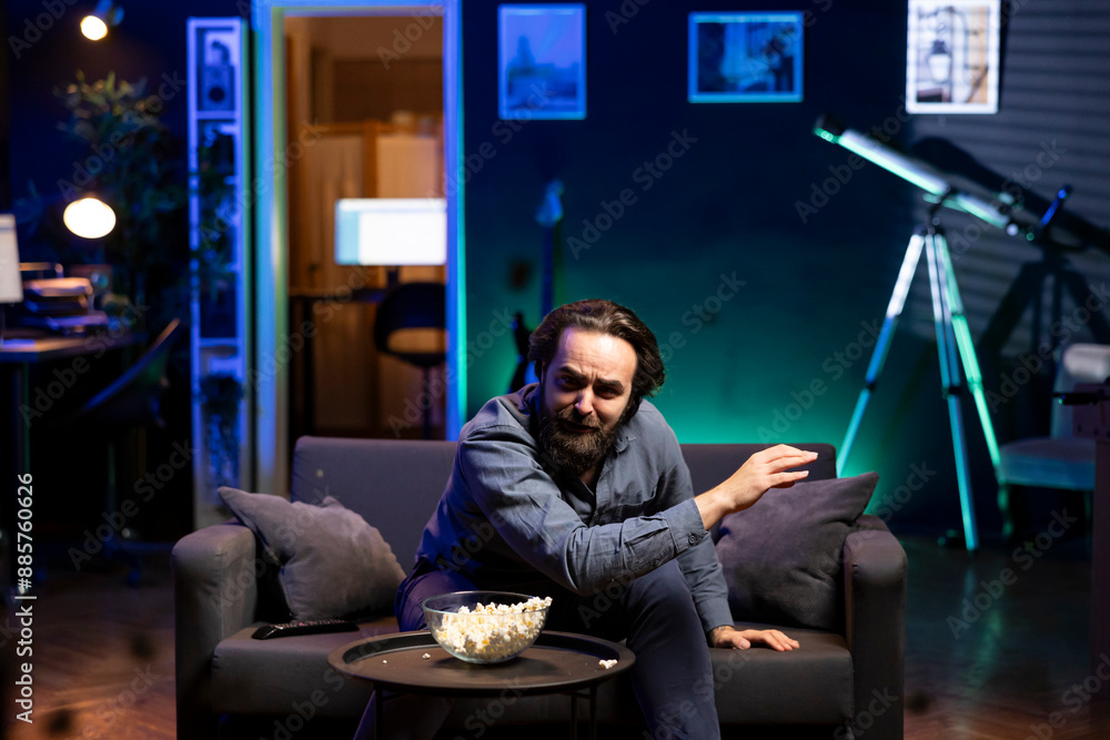 Sad man crying while watching drama movie on streaming service during ...