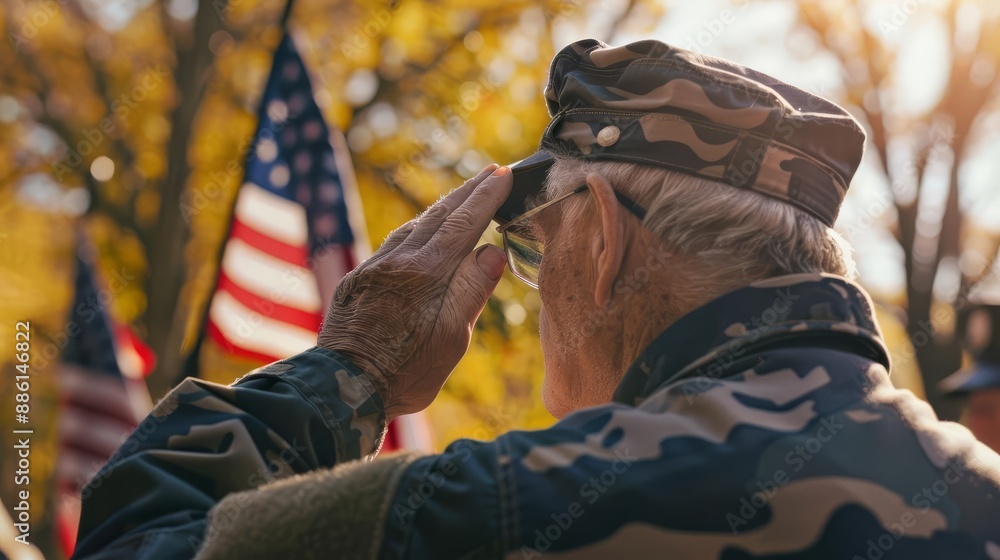 Elderly veteran saluting in uniform with American flags in the ...